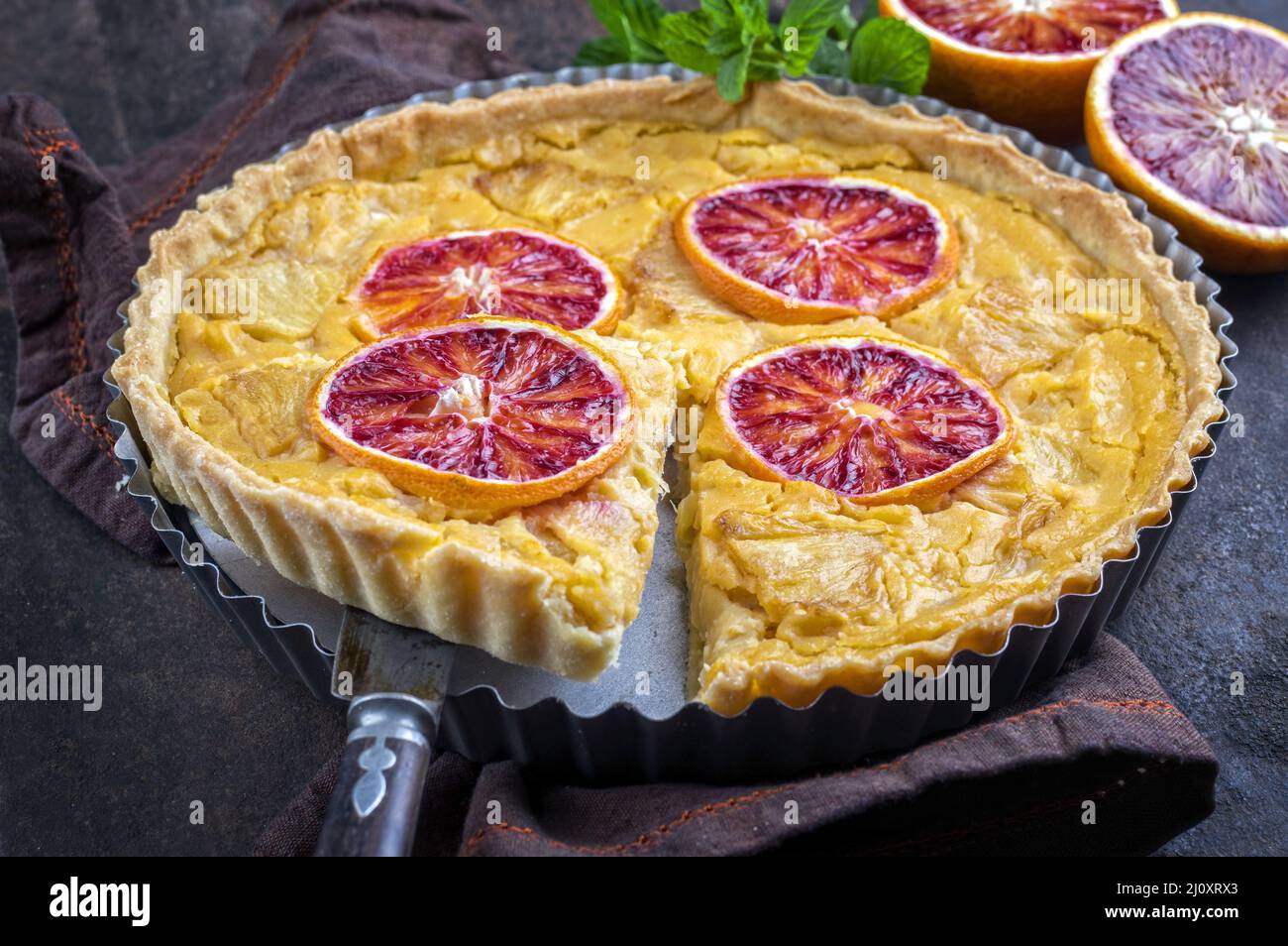 Traditional French tart au citron with blood orange slices served as ...