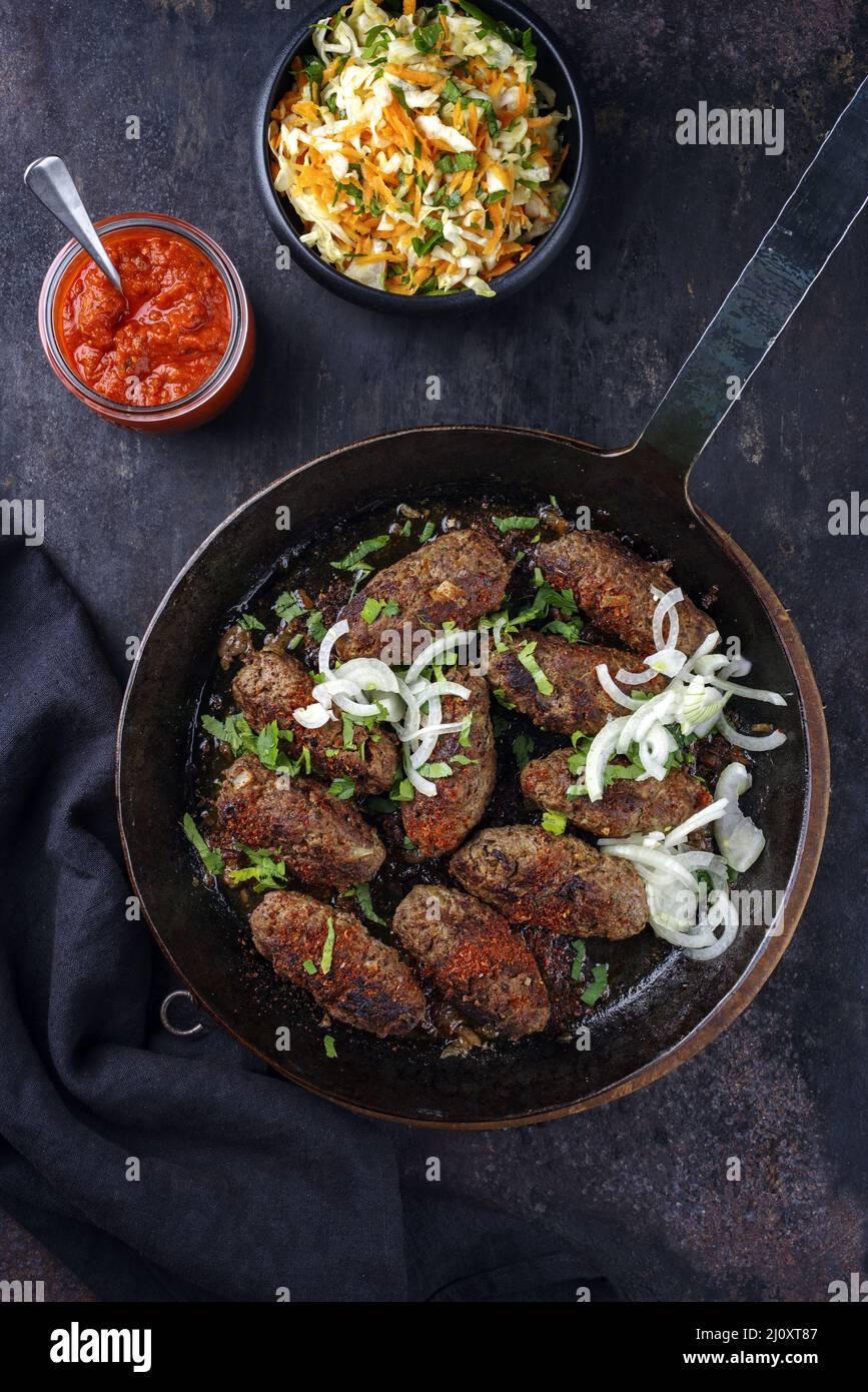 Traditional Croatian cevapcici spicy meat ball rolls with cabbage ...