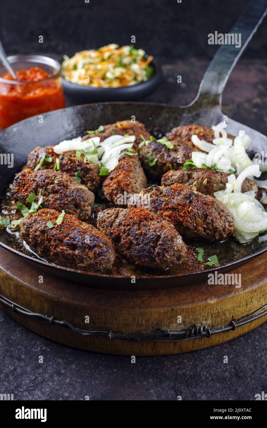 Traditional Croatian cevapcici spicy meat ball rolls with cabbage ...