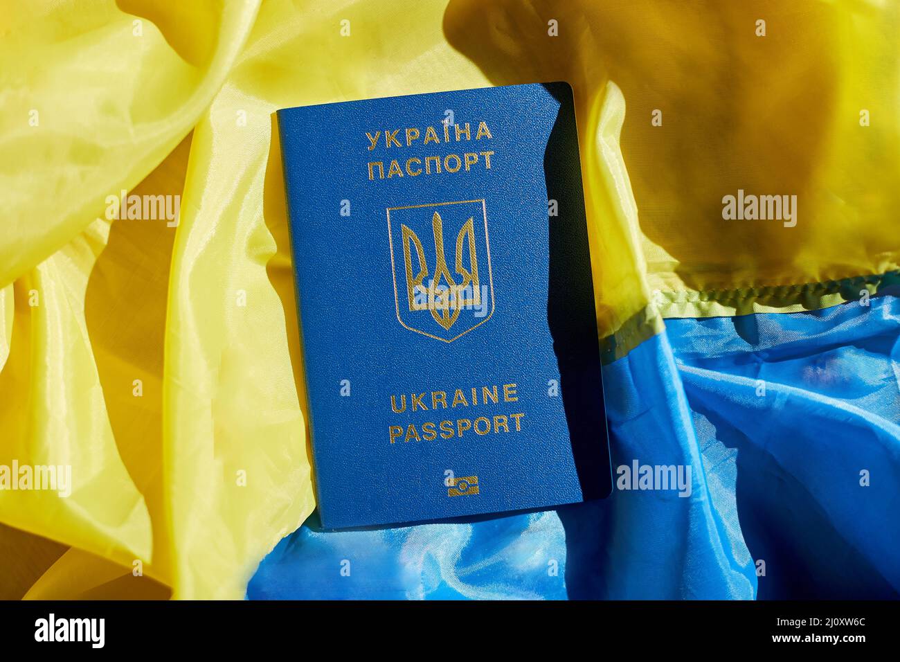 Ukrainian biometric passport on the flag of Ukraine Stock Photo - Alamy