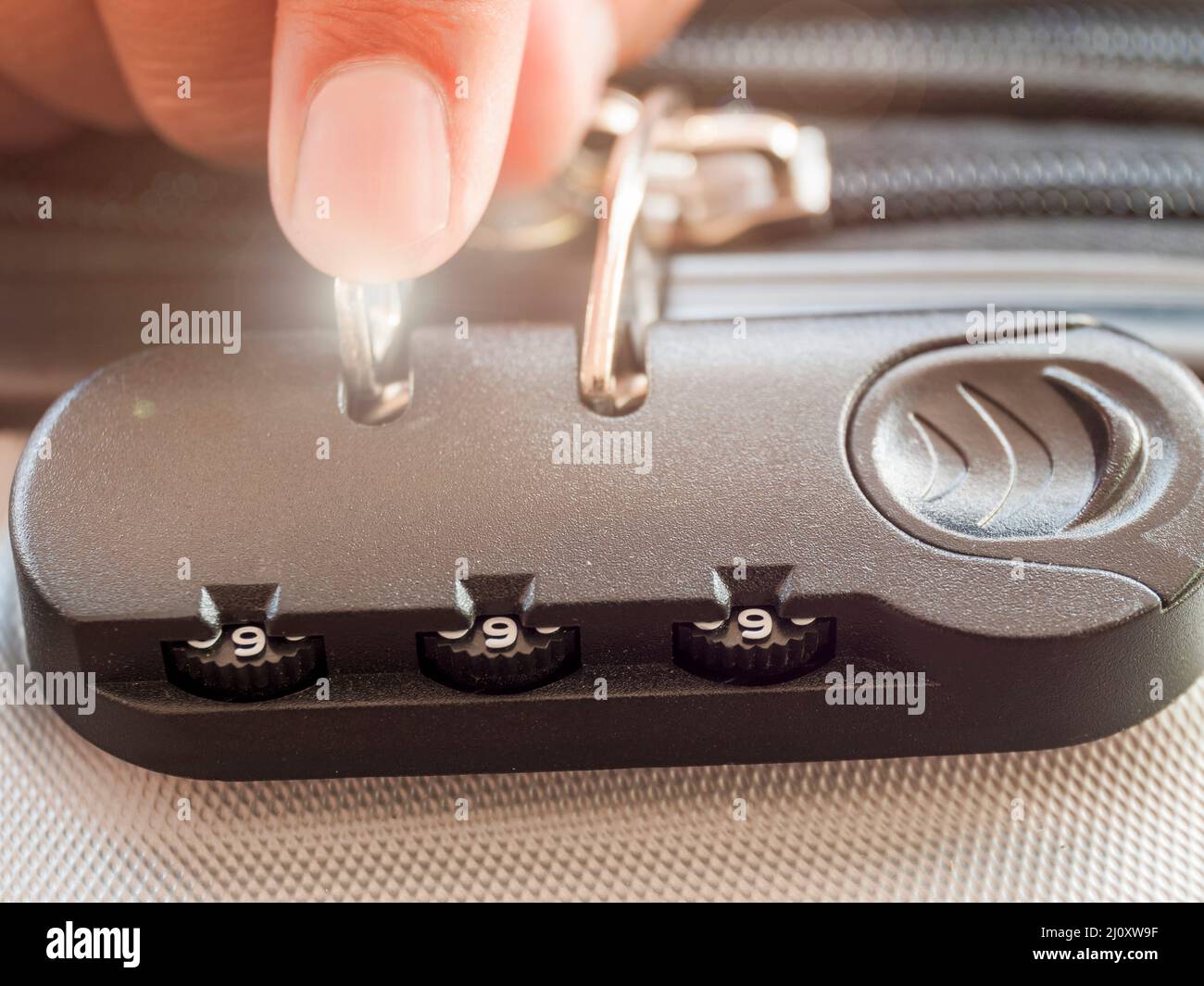 close up hand man close suitcase with combination lock Stock Photo - Alamy