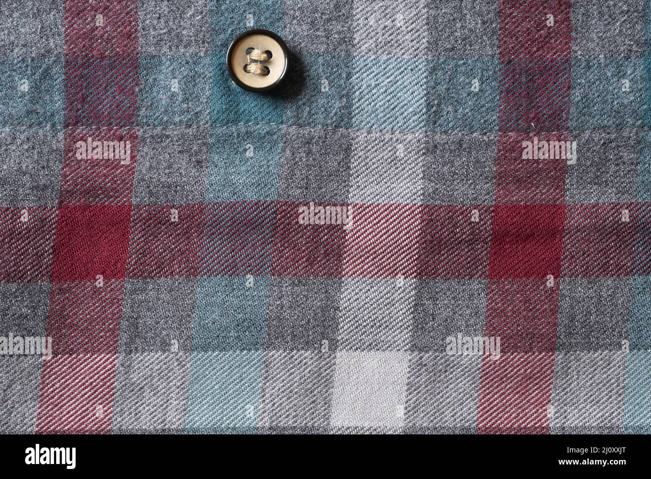 Button on a cloth with plaid pattern Stock Photo - Alamy