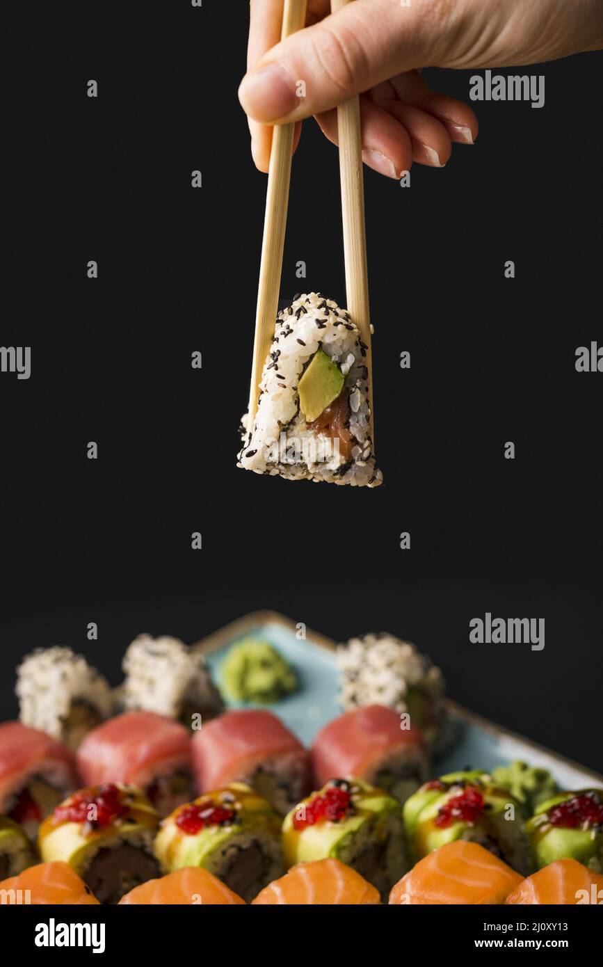 Human hands holding plate sushi hi-res stock photography and images - Alamy