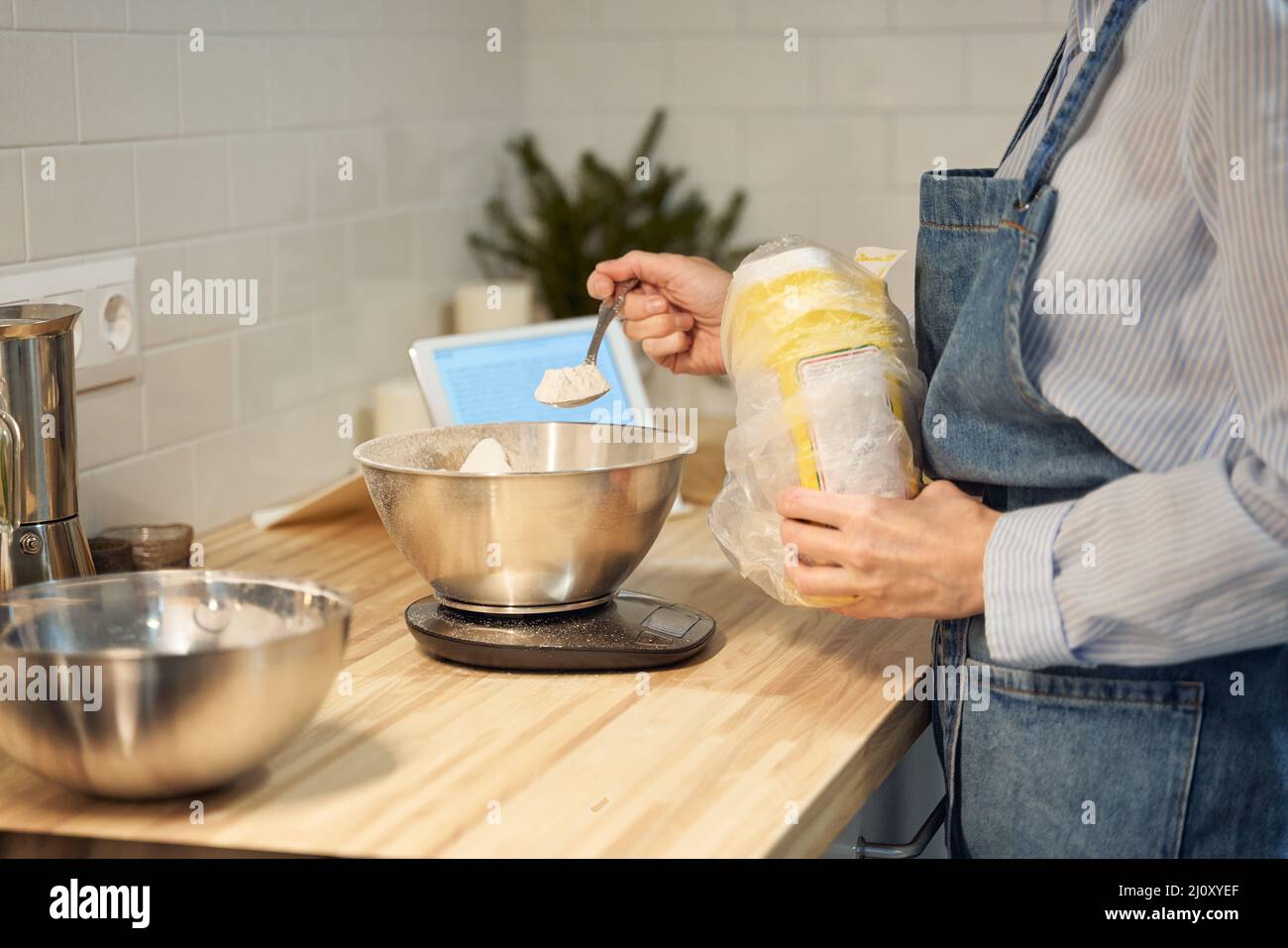 Faceless woman cooking and baking dough on kitchen table at home Stock ...