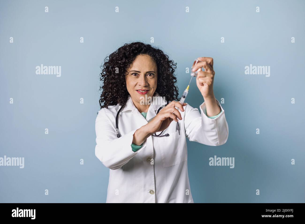 hispanic woman doctor holding vaccine injection in Mexico latin America ...