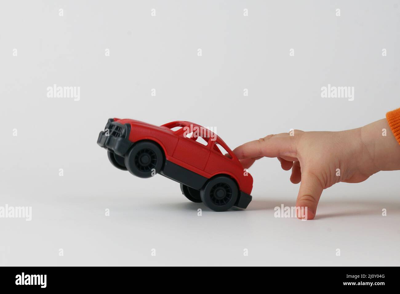 Image of red toy car touching with finger by child, isolated on white ...