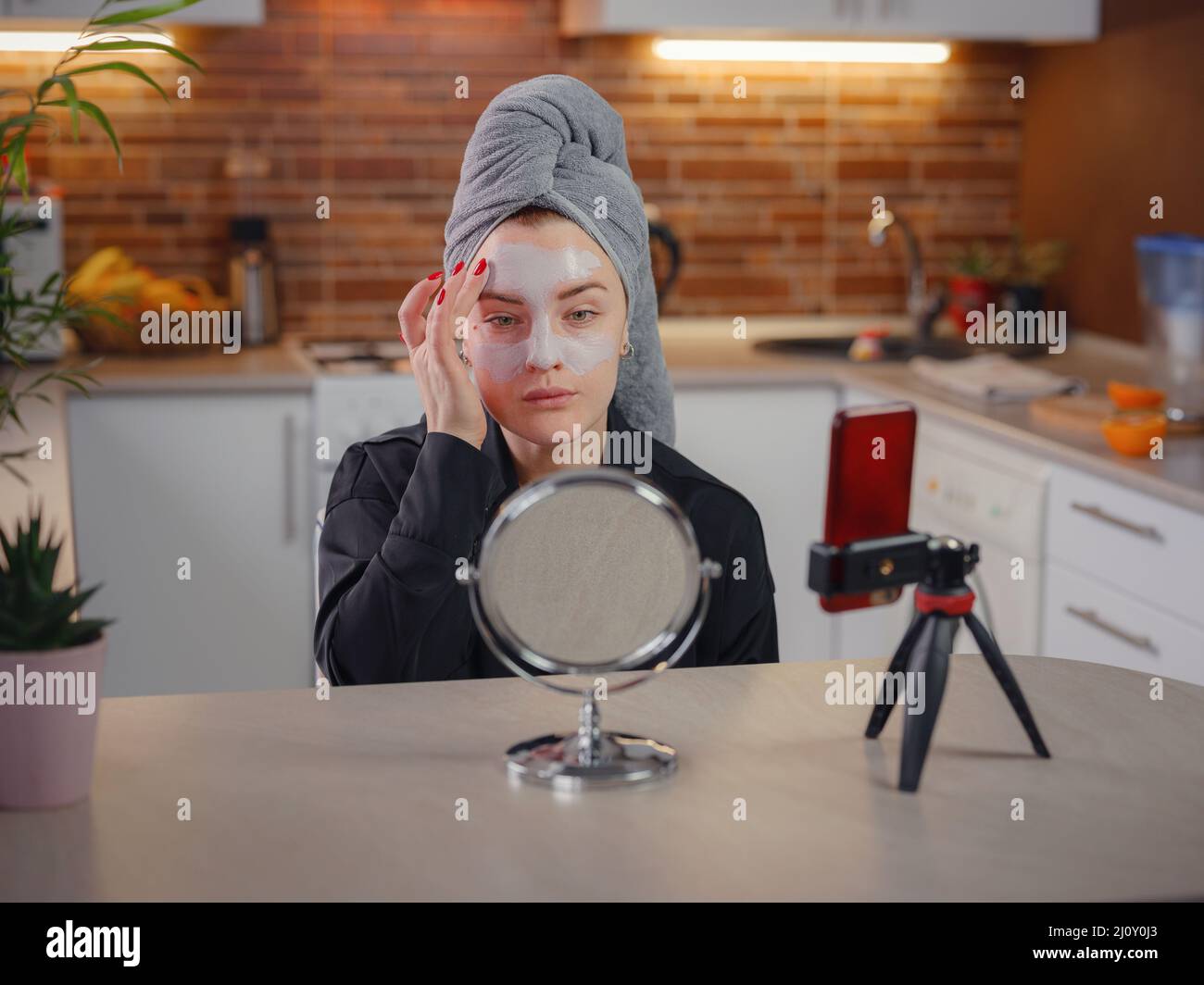 Famous blogger. Cheerful female vlogger showing beauty mask while ...