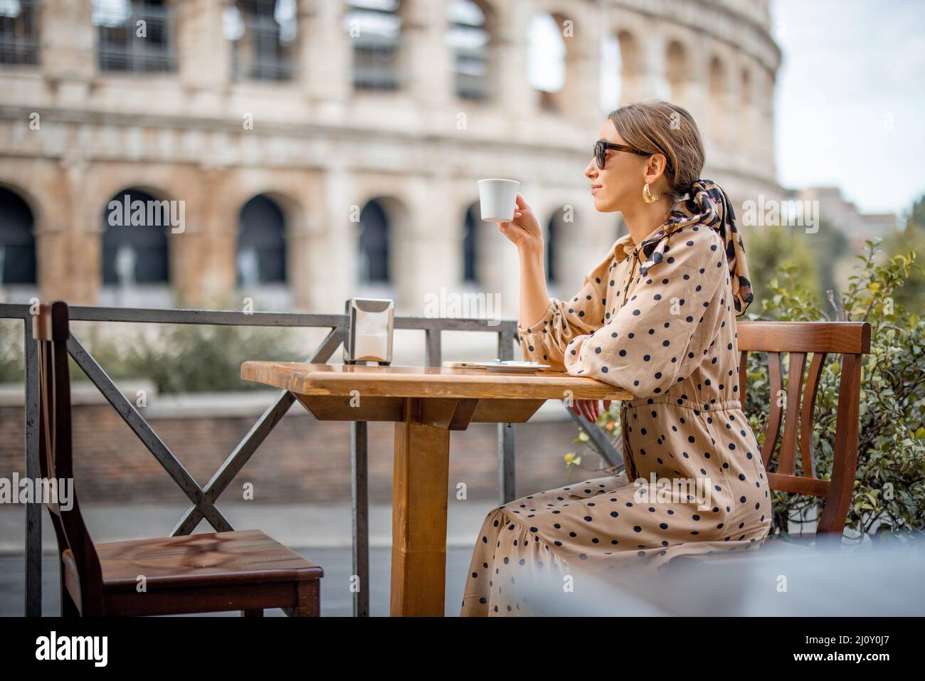 Woman at outdoor cafe in front of coliseum in Rome, Italy Stock Photo ...