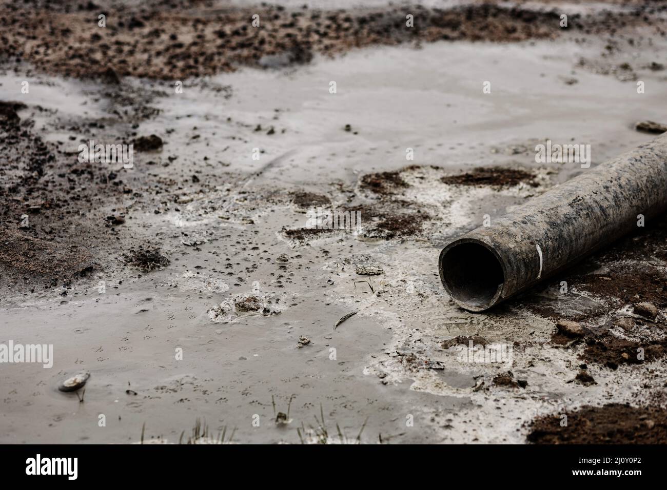 old worn-out pipe on the ground. industrial emissions into the soil ...
