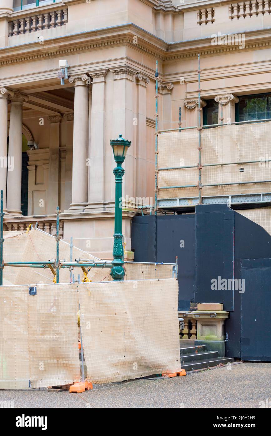 Scaffolding mesh screens covering the Sydney Town Hall are coloured the ...