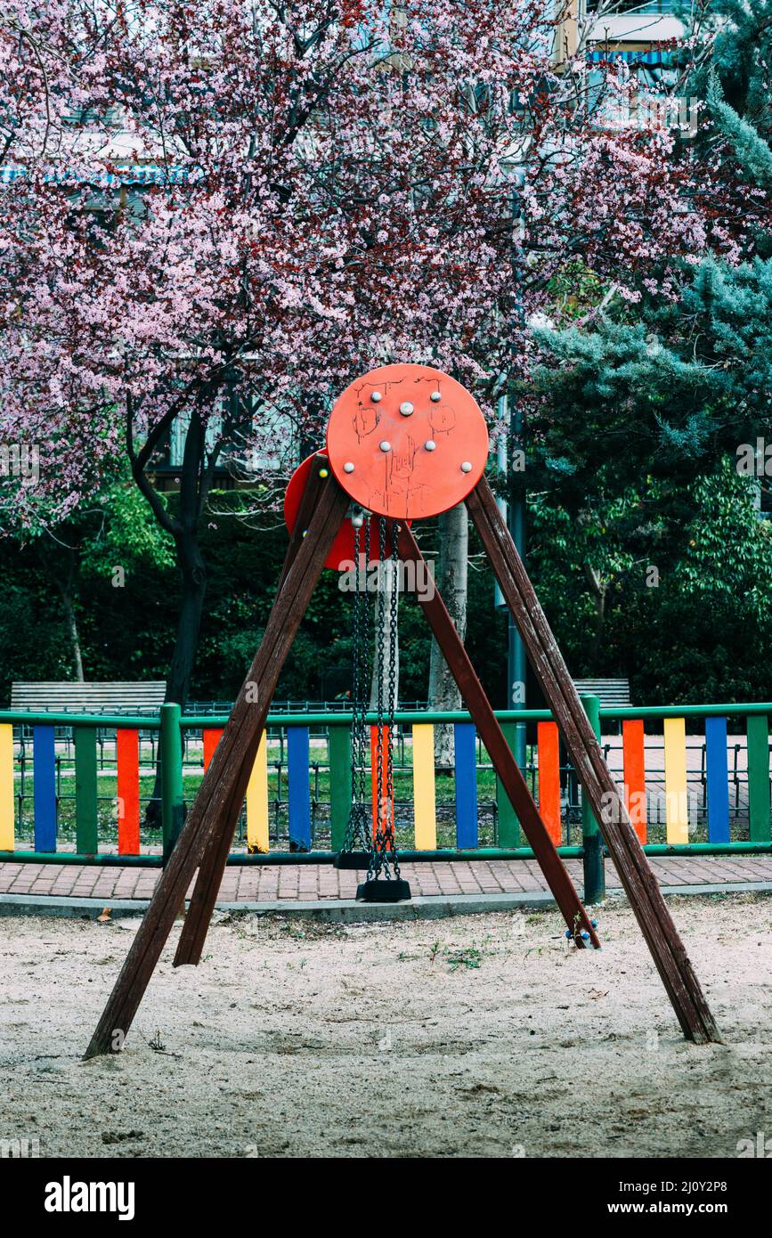 Vertical shot of children swings in playground for children in ...