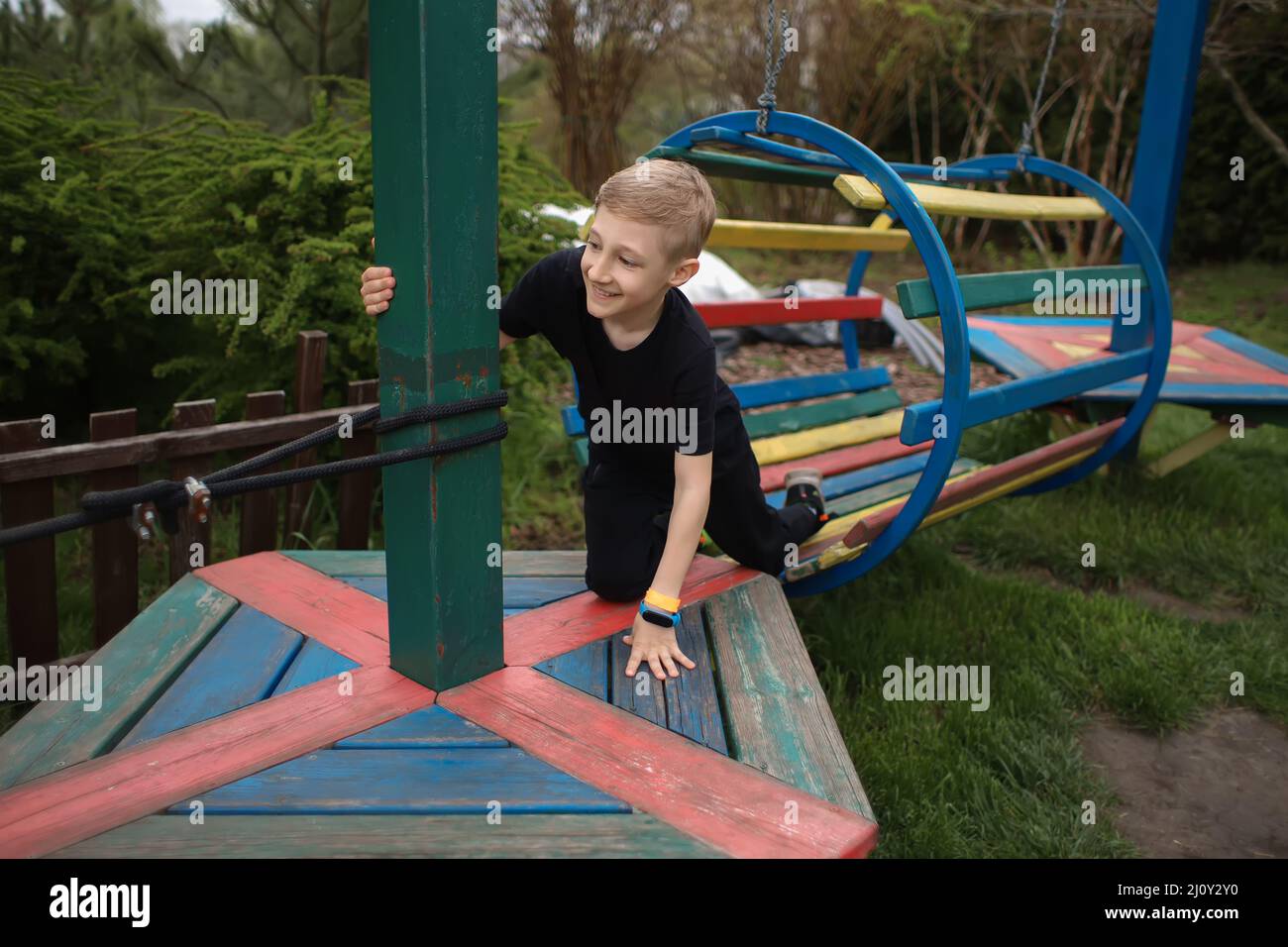 the boy passes an obstacle course is engaged in an active sport climbed ...