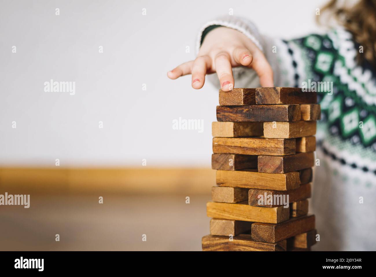 Girl s hand stacking wooden blocks Stock Photo - Alamy