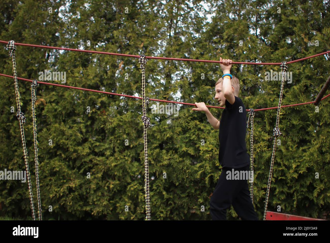 the boy goes through an obstacle course, goes in for active sports ...