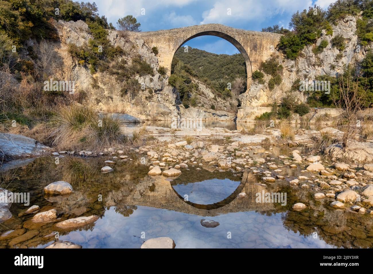 View of an ancient bridge Pont de Llierca in Catalonia, Spain. This ...