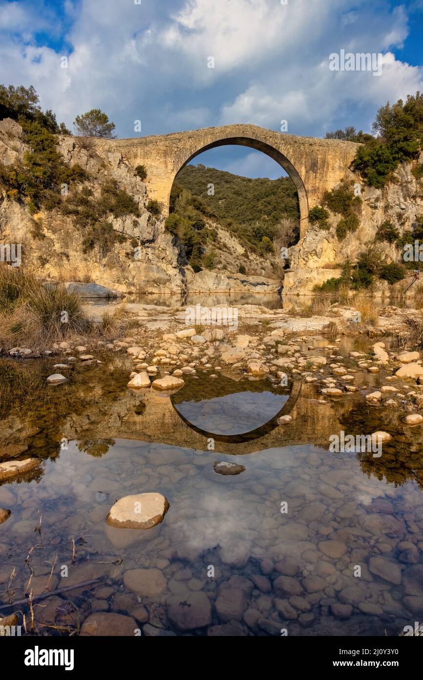 View of an ancient bridge Pont de Llierca in Catalonia, Spain. This ...