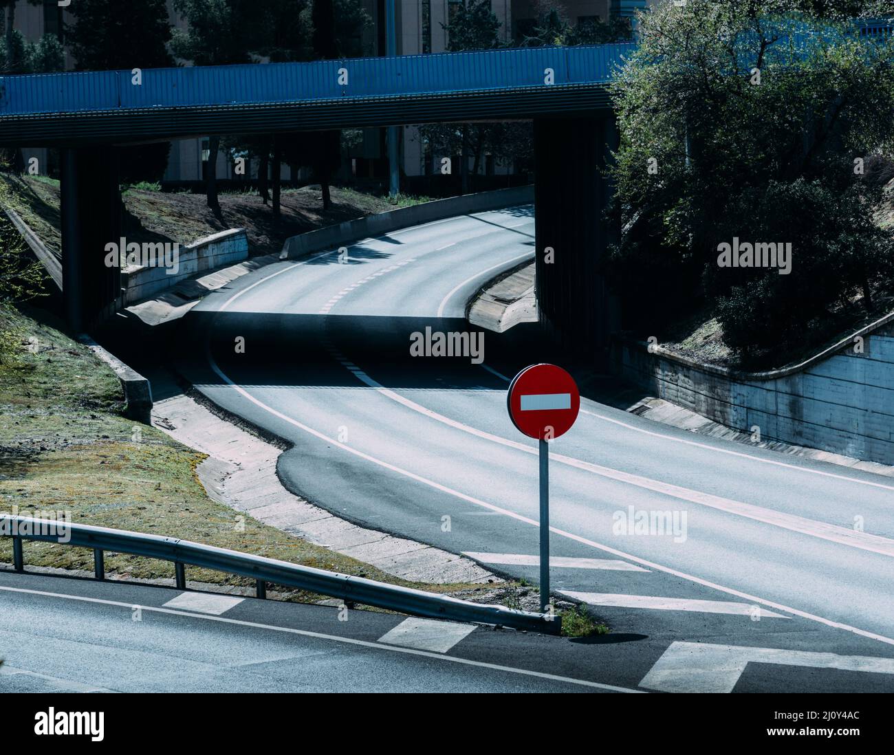 View of 'no entry' traffic sign on road in background of road curve ...