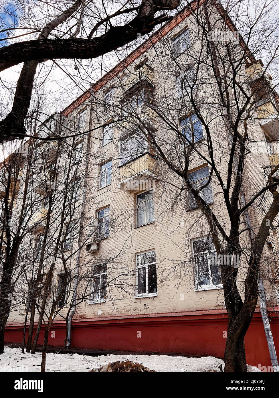 Russian panel house and windows of different apartments. Winter ...