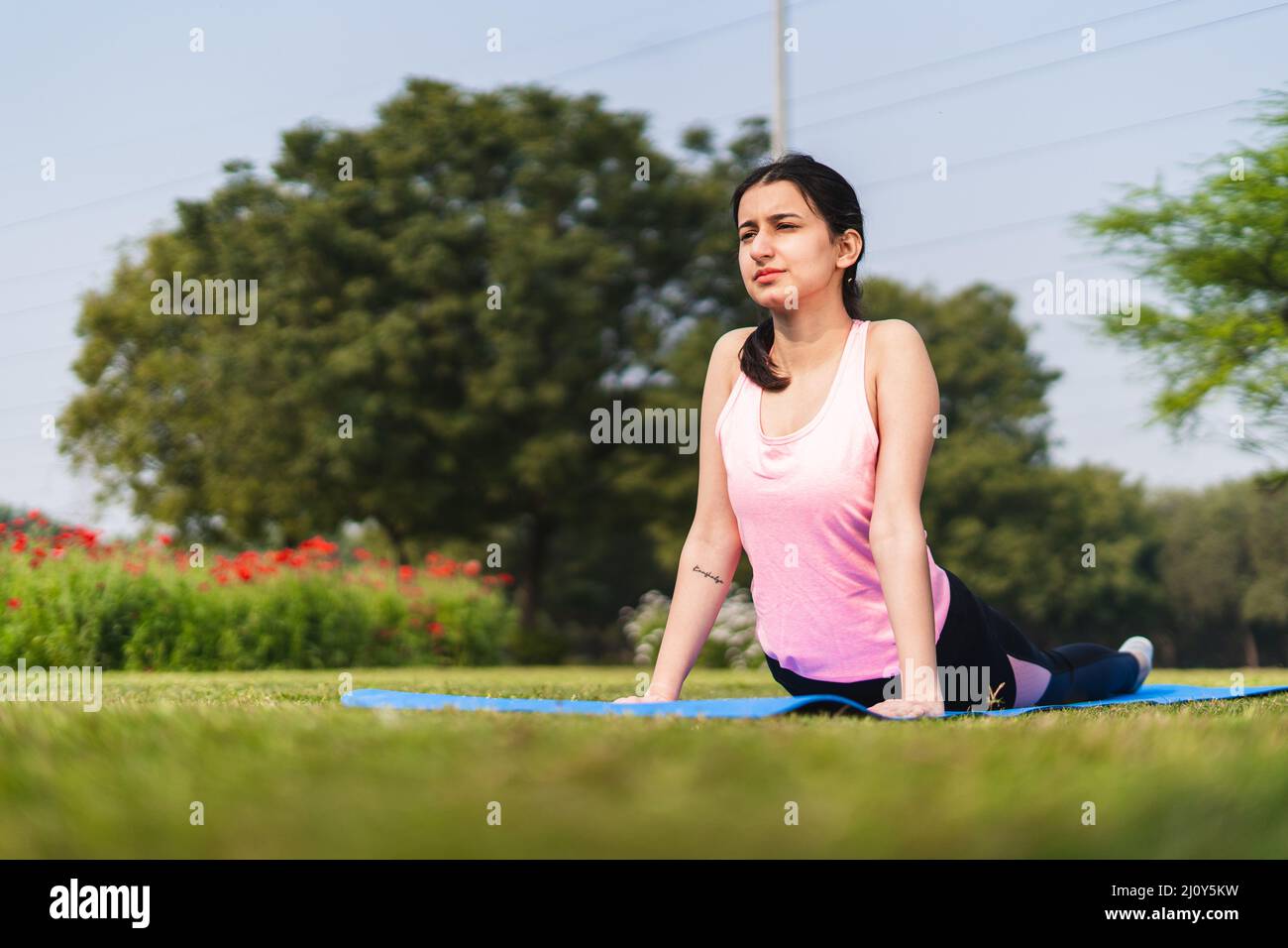 Young indian girl stretching in the park - concept of healthy lifestyle ...