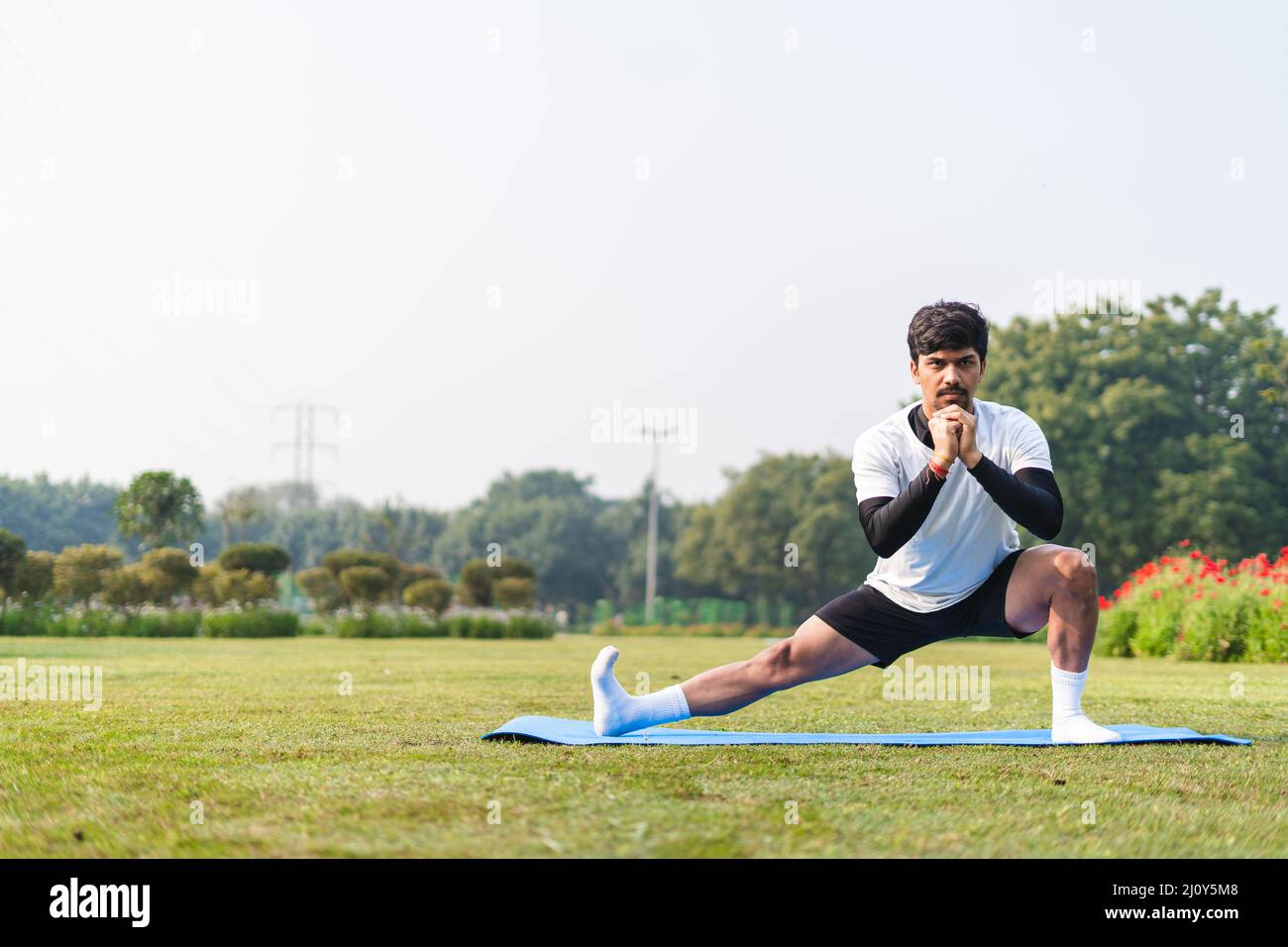Young indian boy stretching and working out in the park - concept of ...