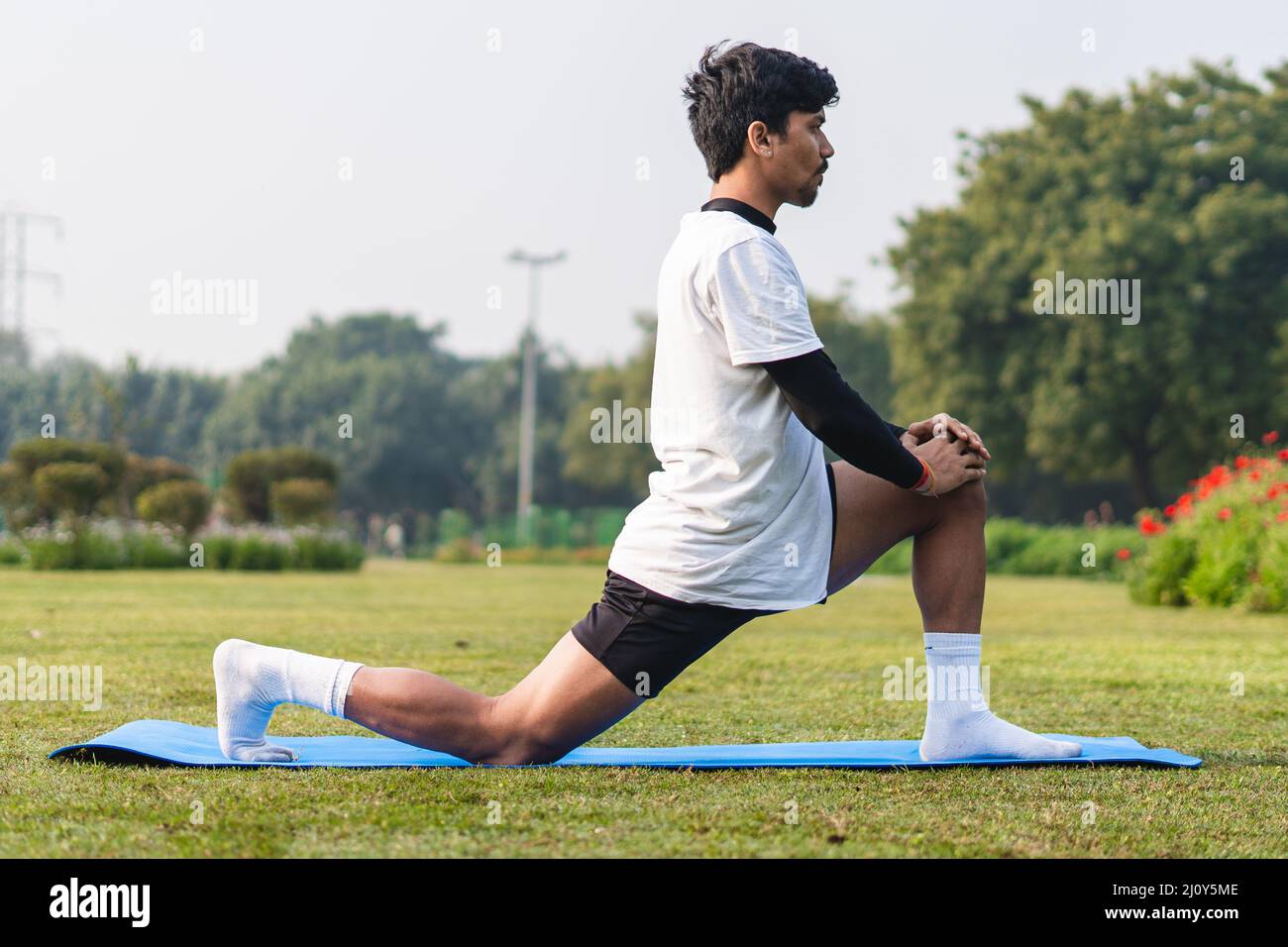 Young indian boy stretching and working out in the park - concept of ...