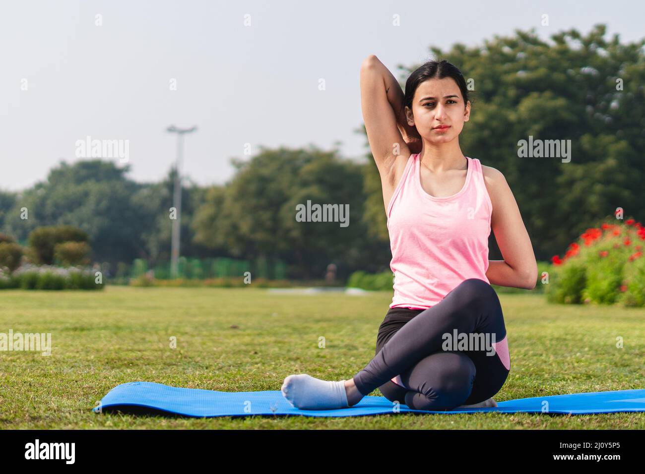 Young indian girl stretching in the park - concept of healthy lifestyle ...