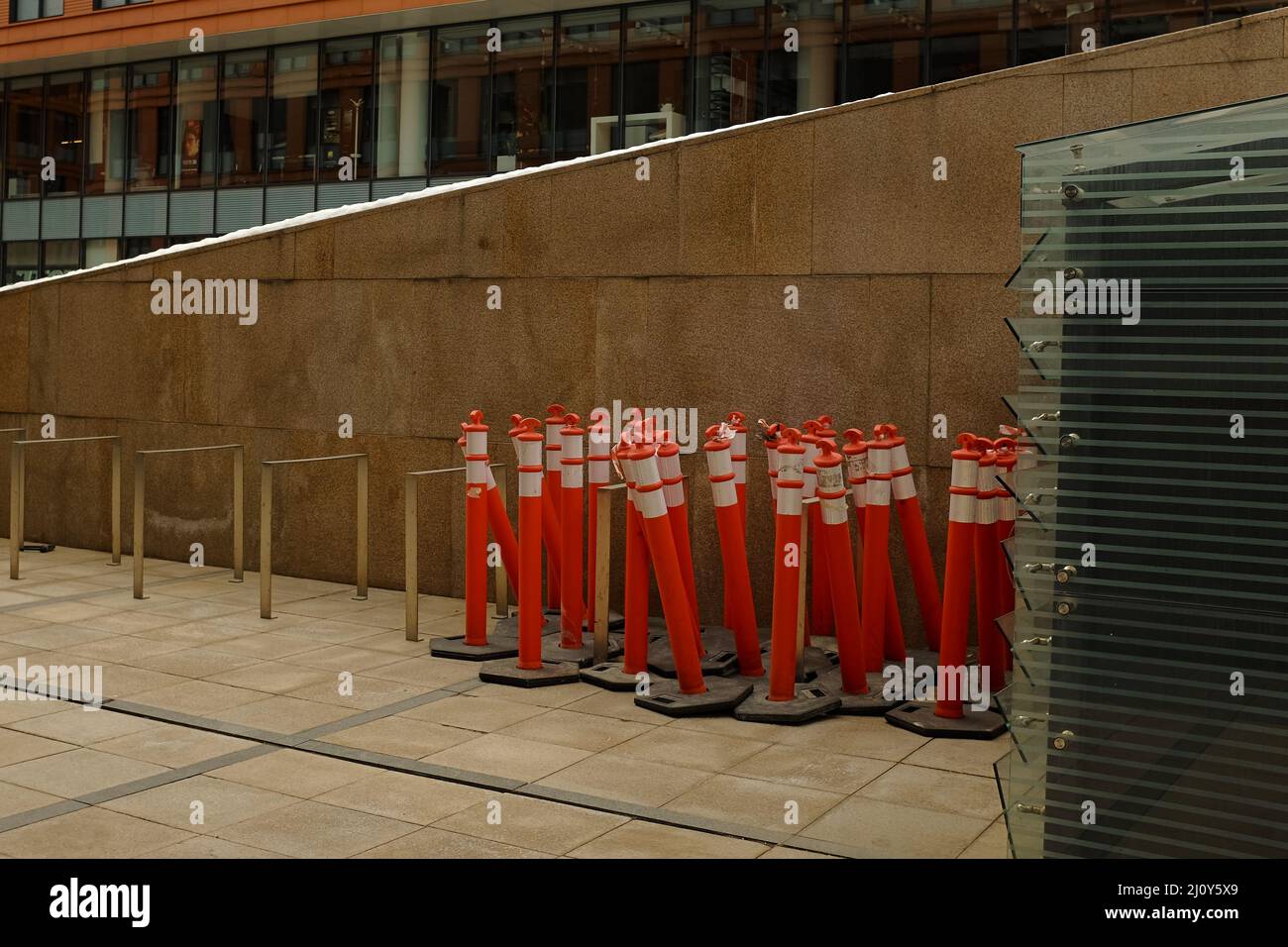Red fence posts stand in corner. Business district, office building ...