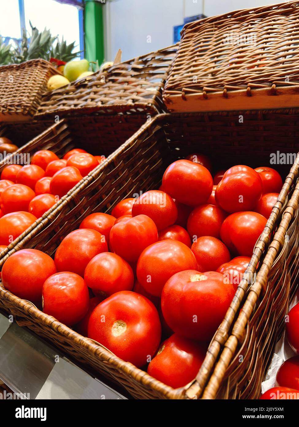 In eco farm store, red ripe tomatoes are in basket for sale. Small ...