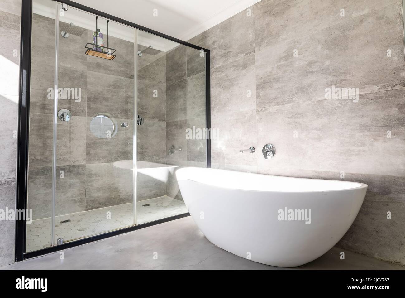 Empty bathtub by modern shower in bathroom at home Stock Photo - Alamy