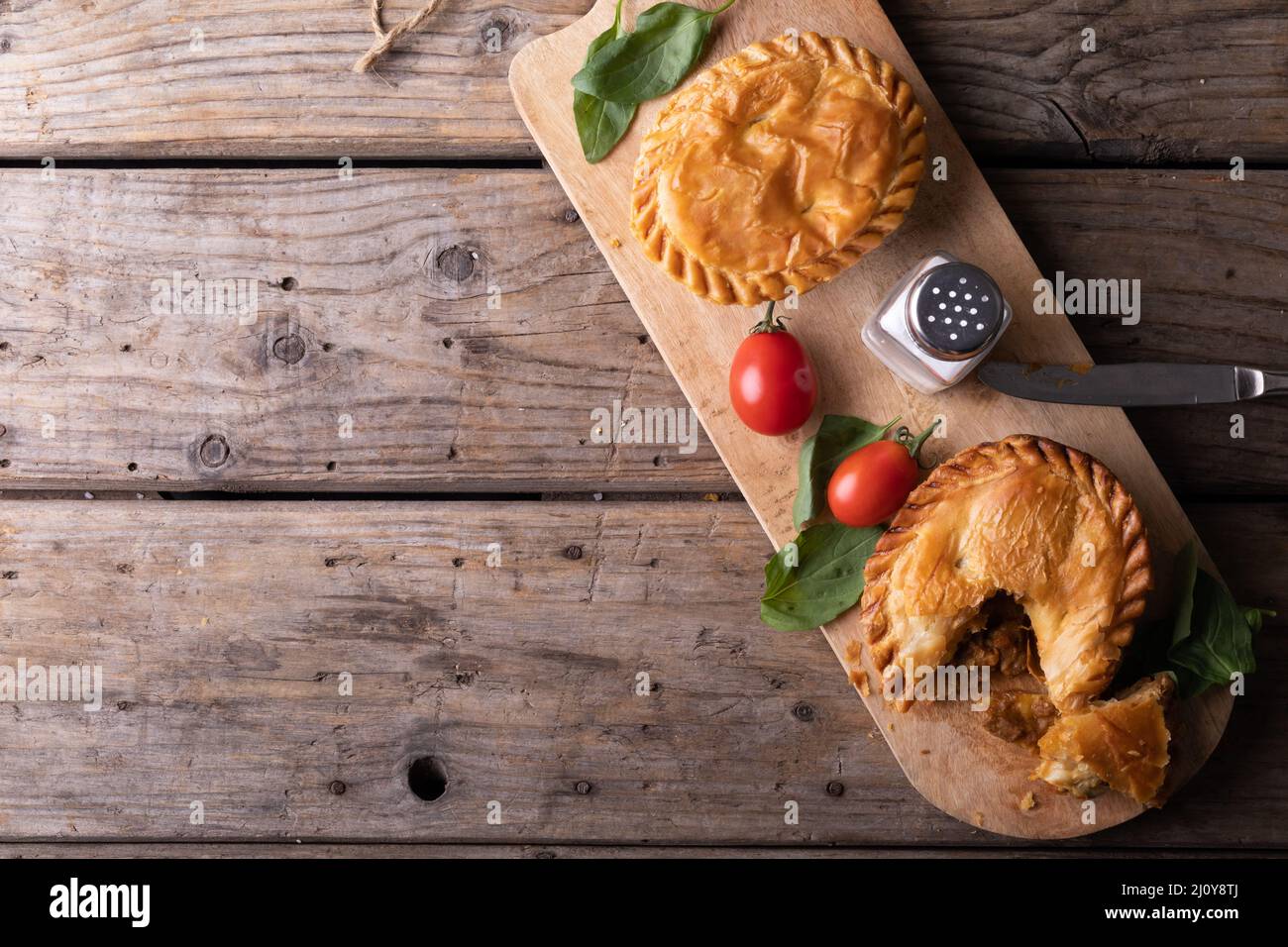 Directly above shot of stuffed pies with tomatoes, herbs and salt ...