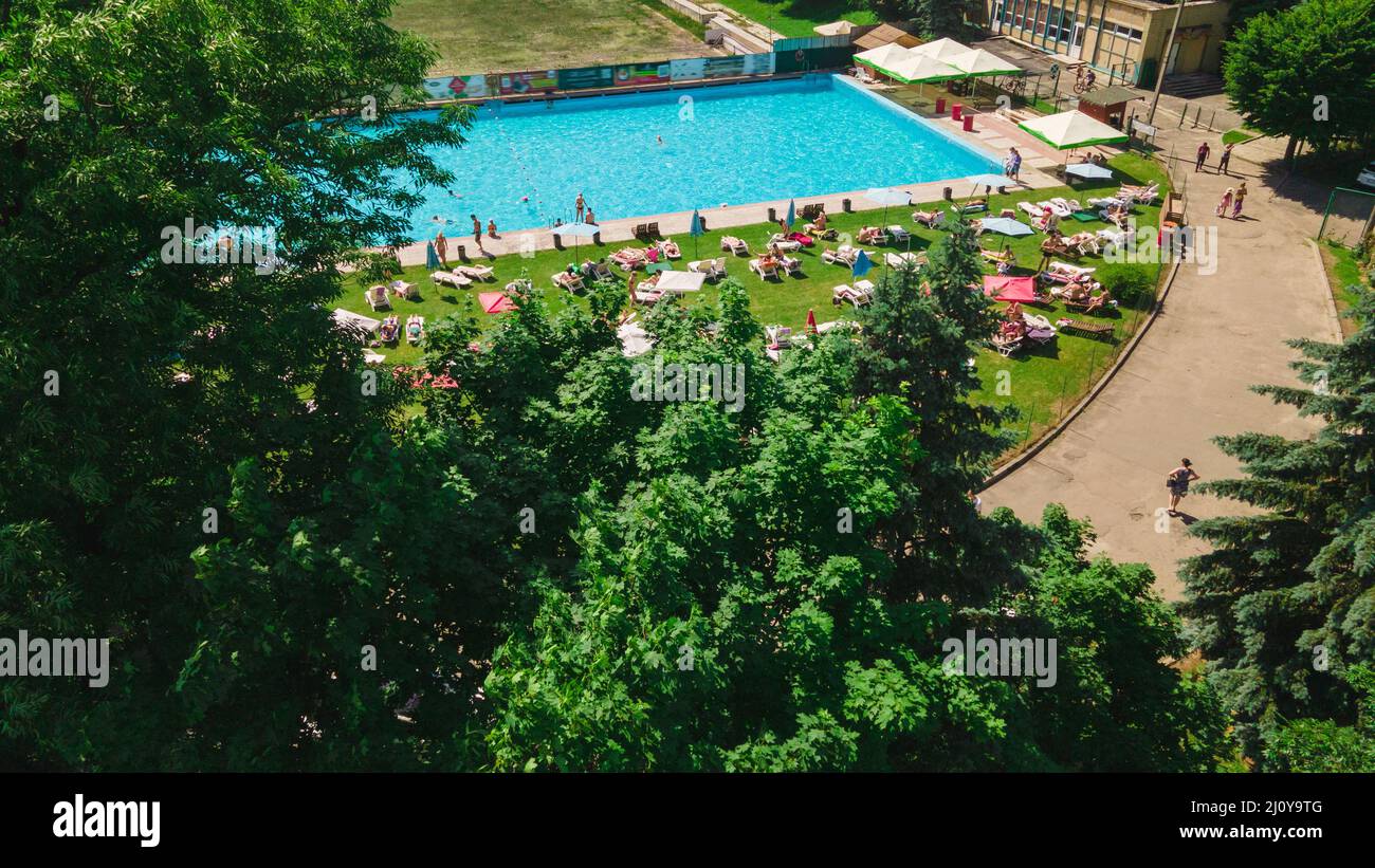 aerial view of people resting sunbathing near city pool outdoors summer ...