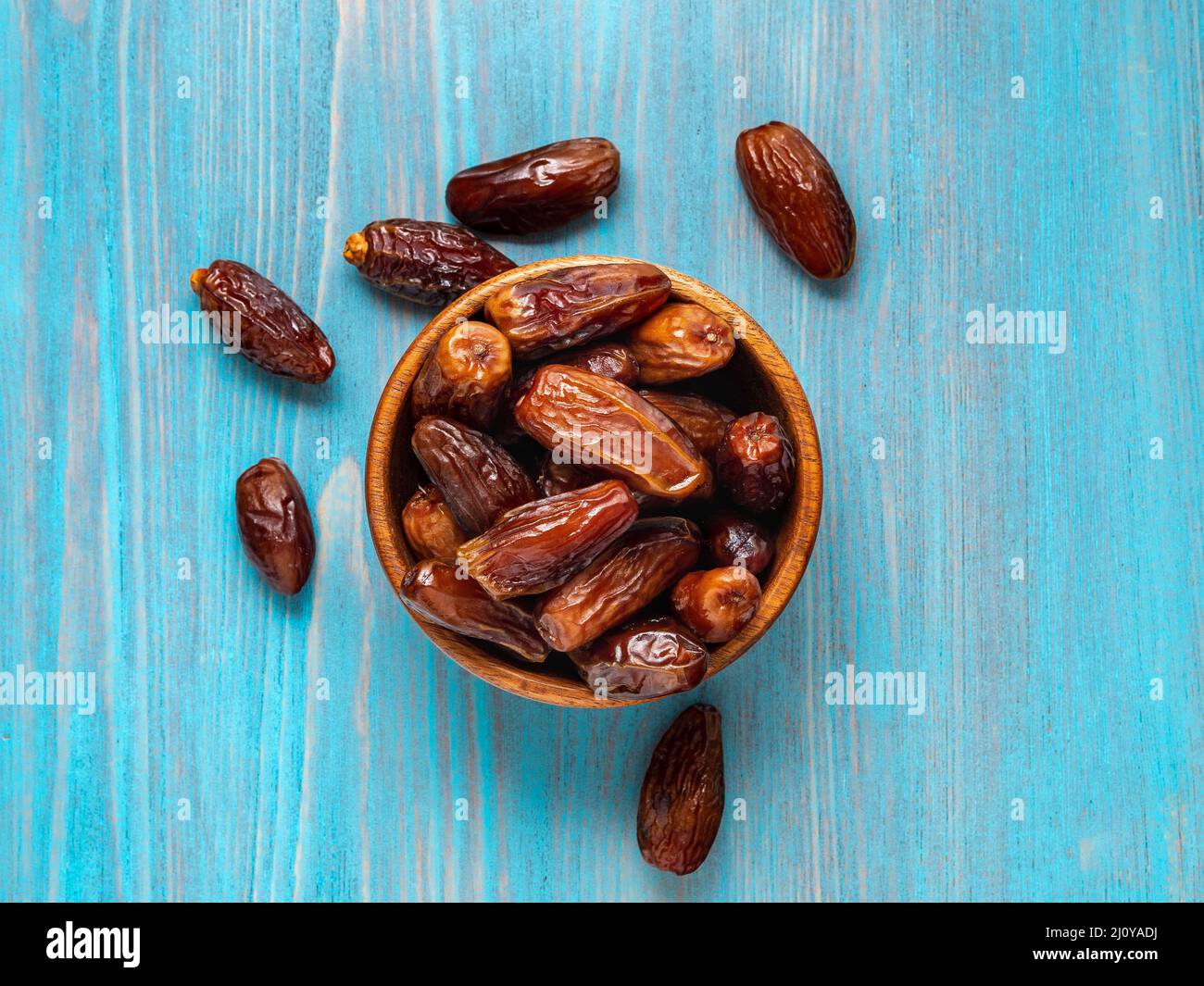 Fruits of date palm, dried fruits in wooden bowl. Traditional food of ...