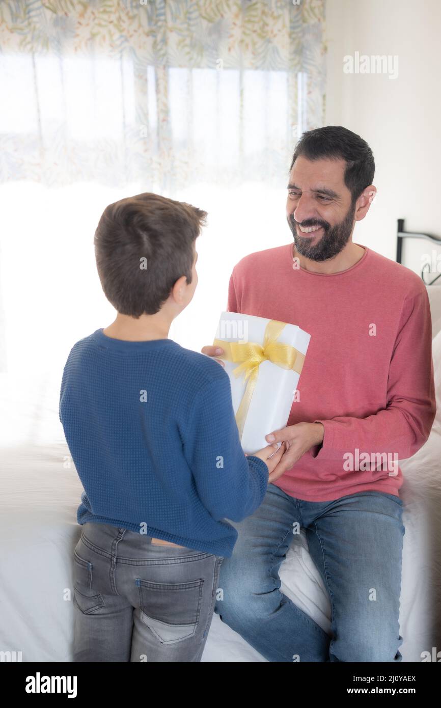 Son giving a gift to his father on father's day Stock Photo - Alamy