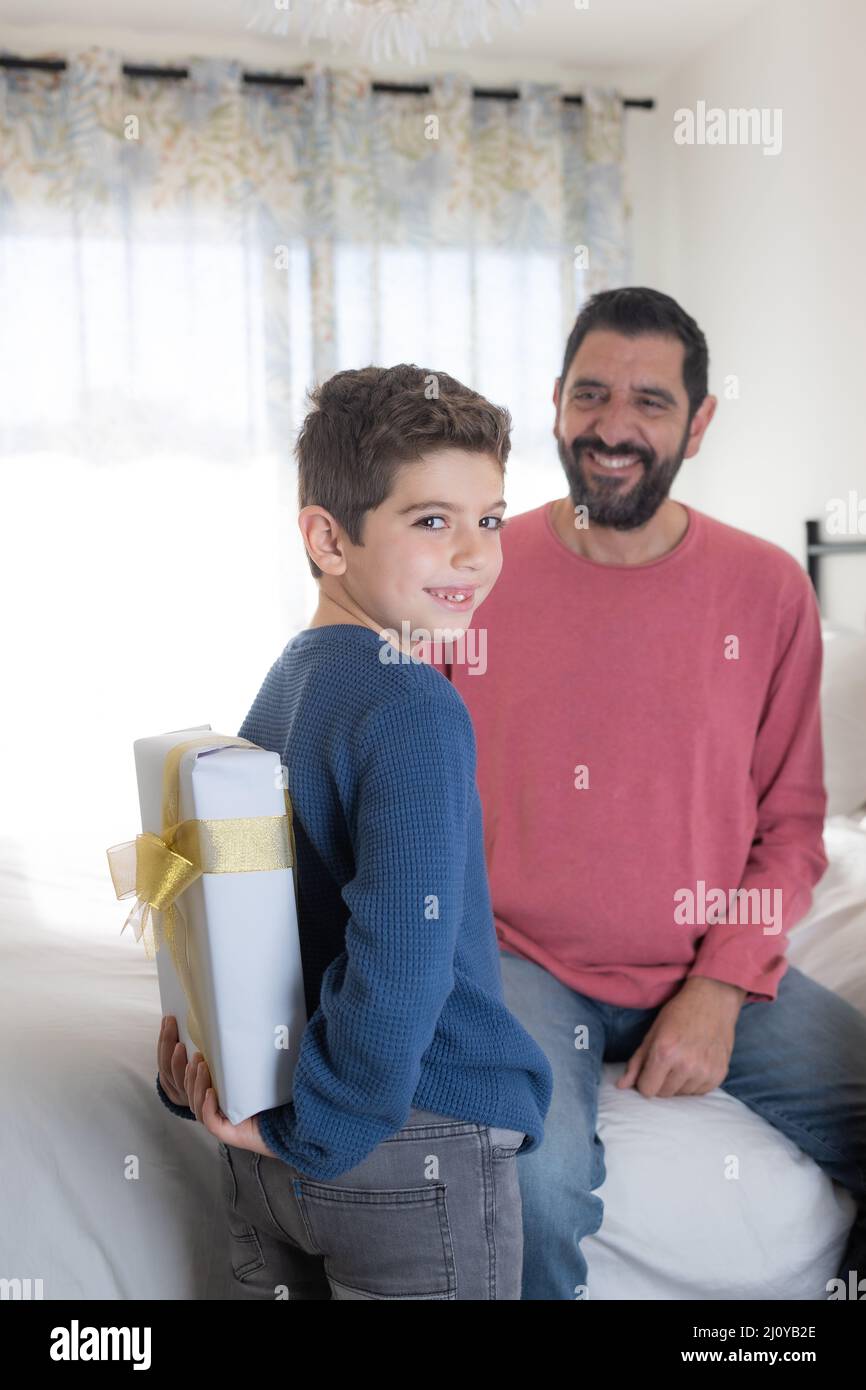 Son giving a gift to his father on father's day Stock Photo - Alamy
