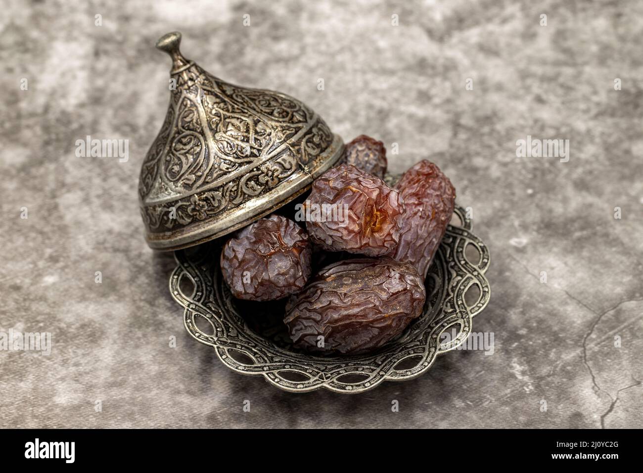 Date fruit on a dark background. Date fruits on a rustic serving plate ...