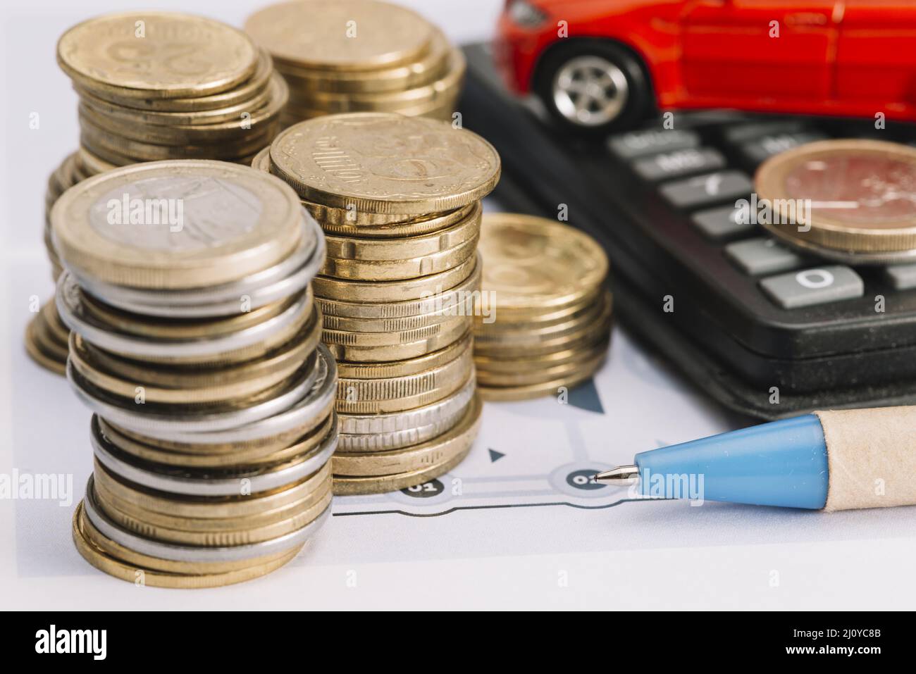 Stacked coins pen calculator. High quality photo Stock Photo - Alamy