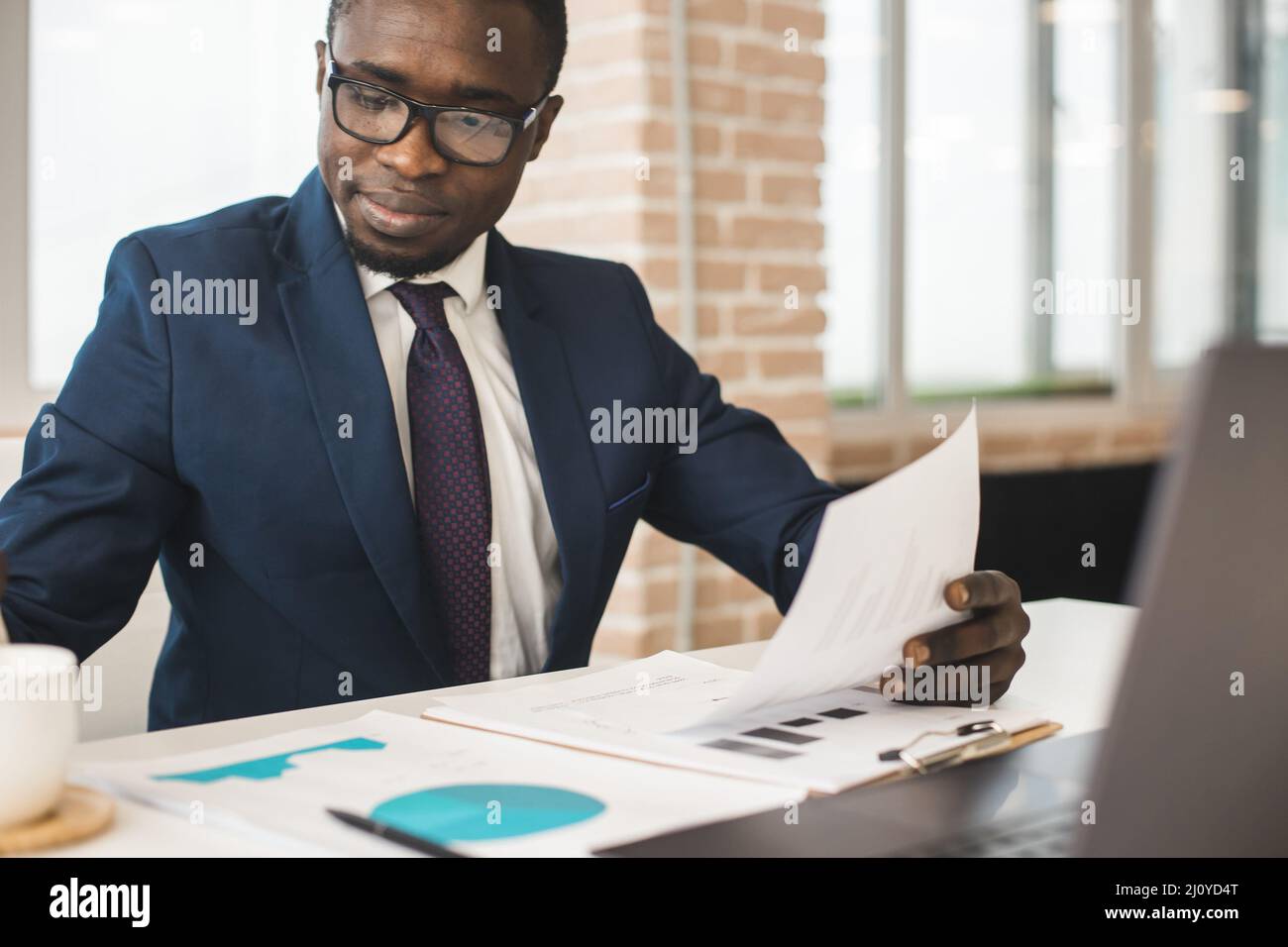 Portrait of an African American in the office. Black man in a business ...