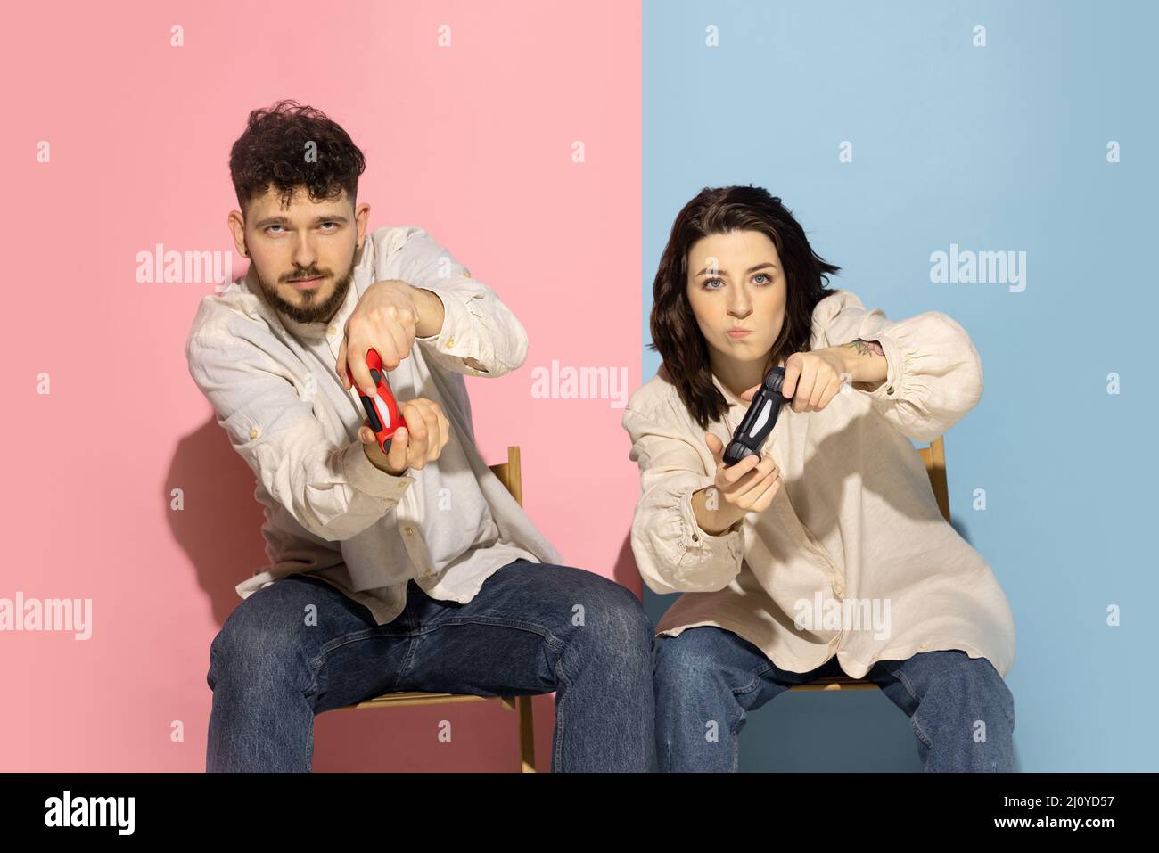 Married couple, young emotive man and girl isolated on blue and pink ...