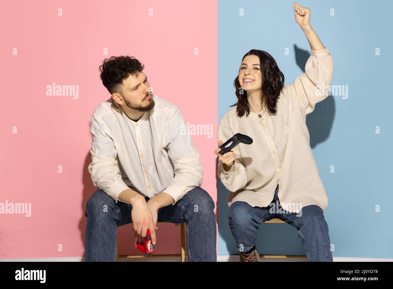 Married couple, young emotive man and girl isolated on blue and pink ...
