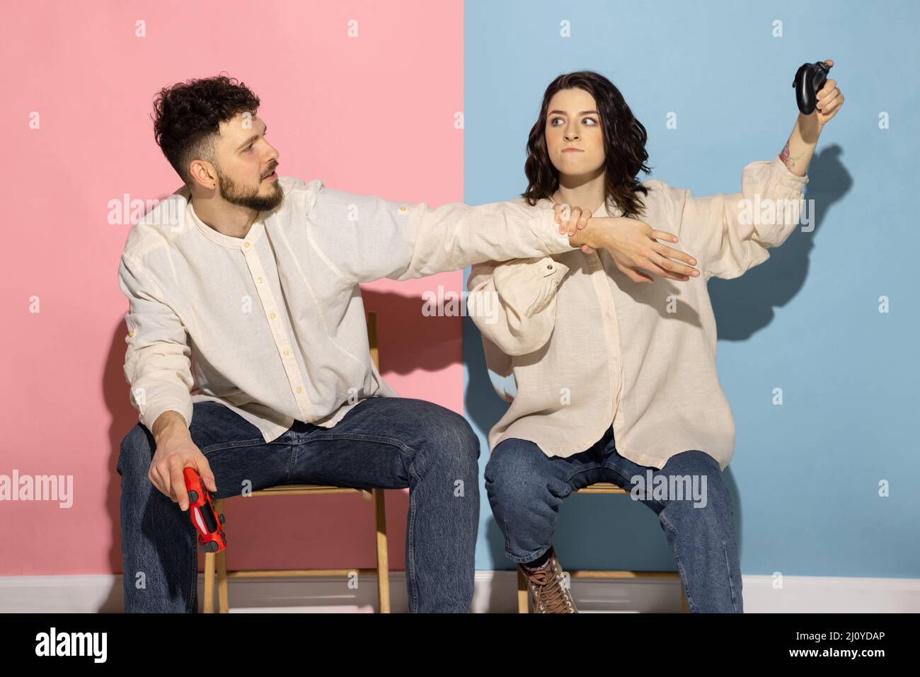 Married couple, young emotive man and girl isolated on blue and pink ...