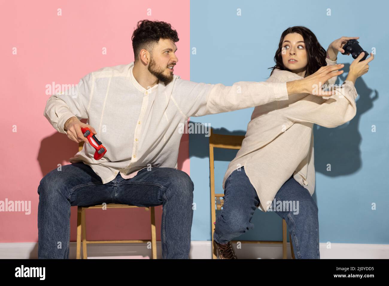 Married couple, young emotive man and girl isolated on blue and pink ...