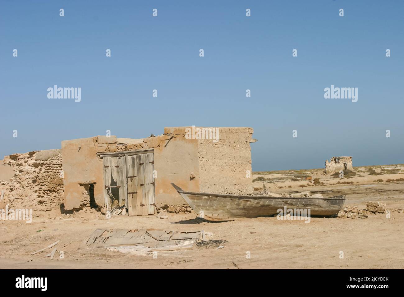 An old shed and fishing boat in Al Jazirat Al Hamra, an abandoned ghost ...