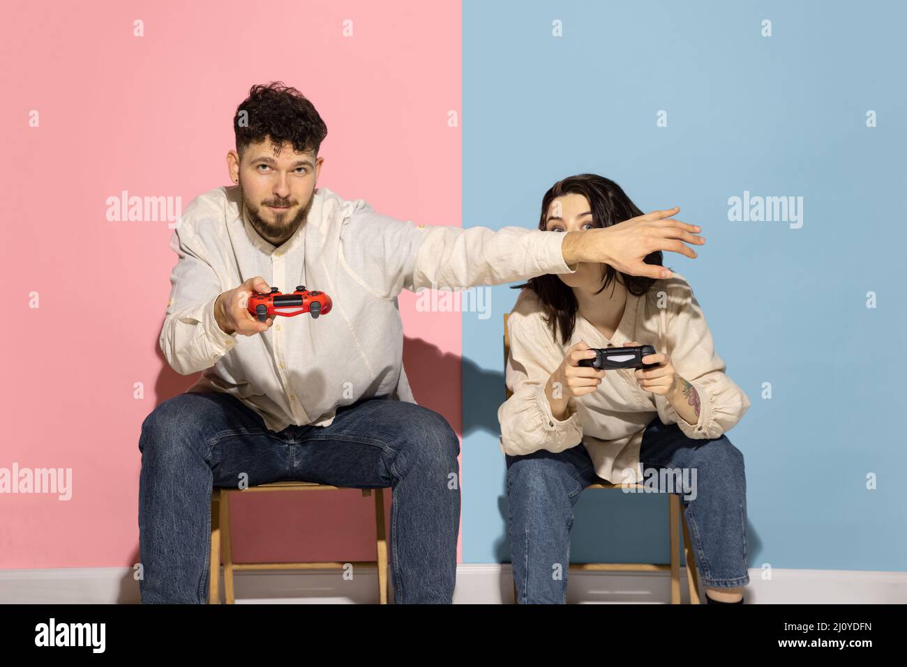 Married couple, young emotive man and girl isolated on blue and pink ...