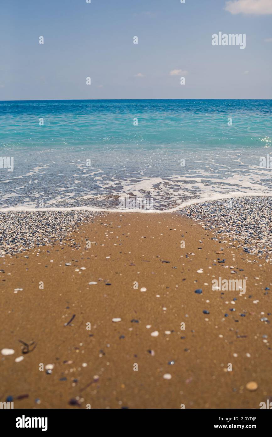 The beach of the Mediterranean coast with waves of azure water. Summer ...