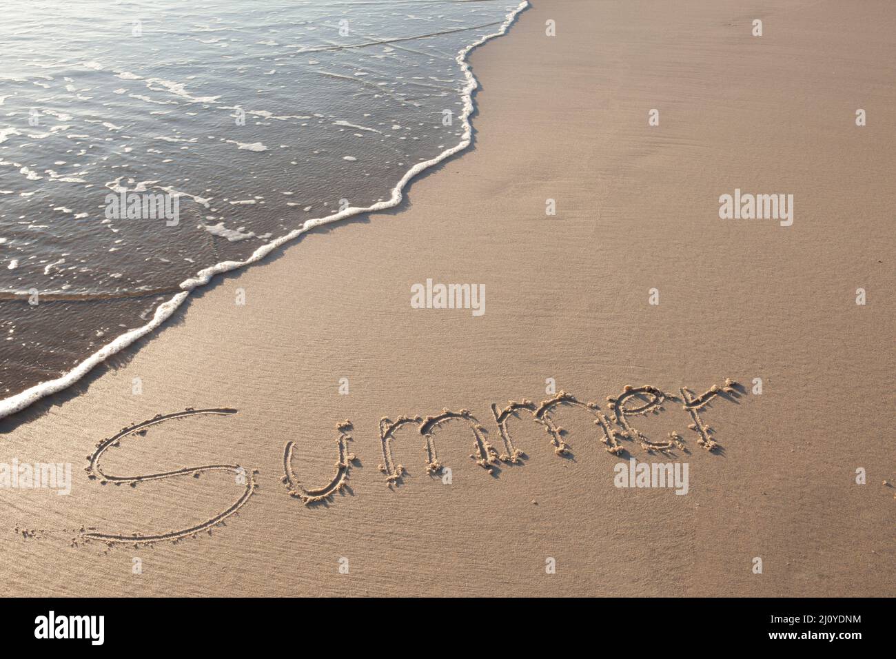 Word "summer" written in sand Stock Photo - Alamy