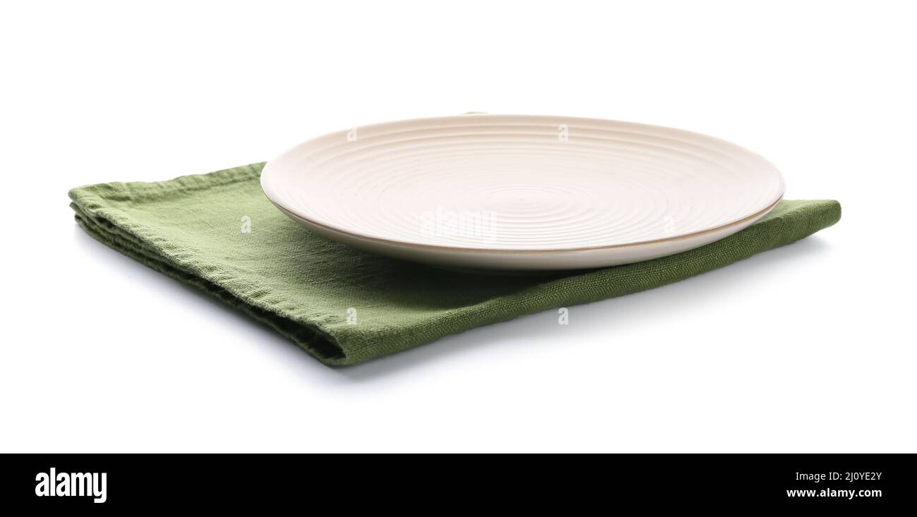 Plate with napkin on white background Stock Photo - Alamy