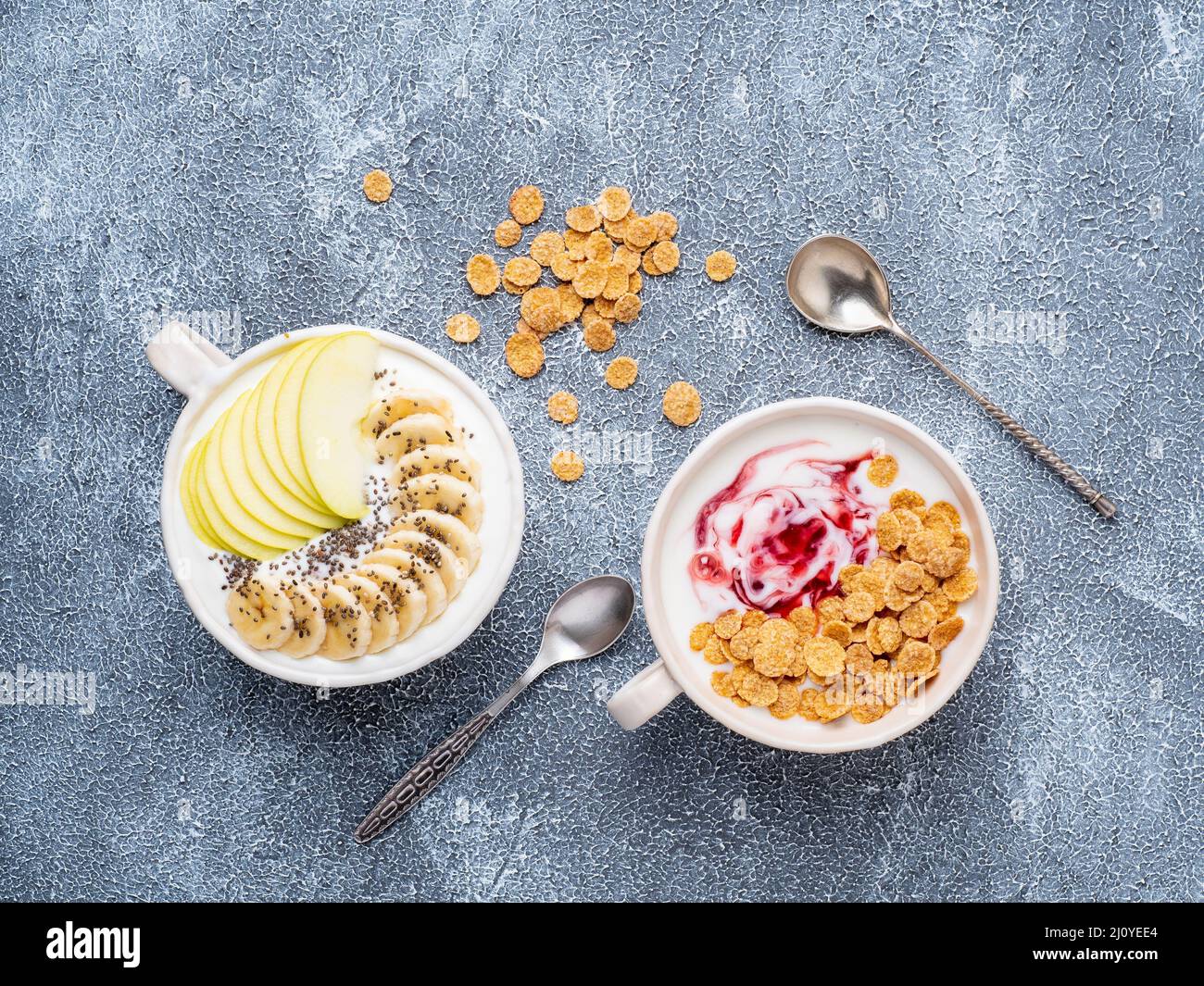Greek yogurt with jam in white bowl on grey blue concrete stone table ...