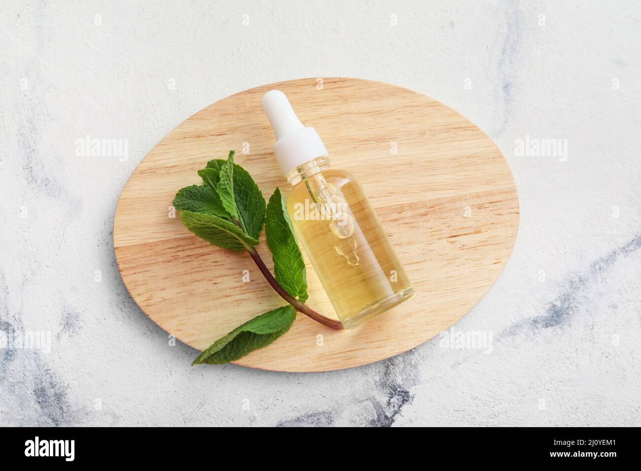 Bottle of natural mint oil on white background Stock Photo - Alamy