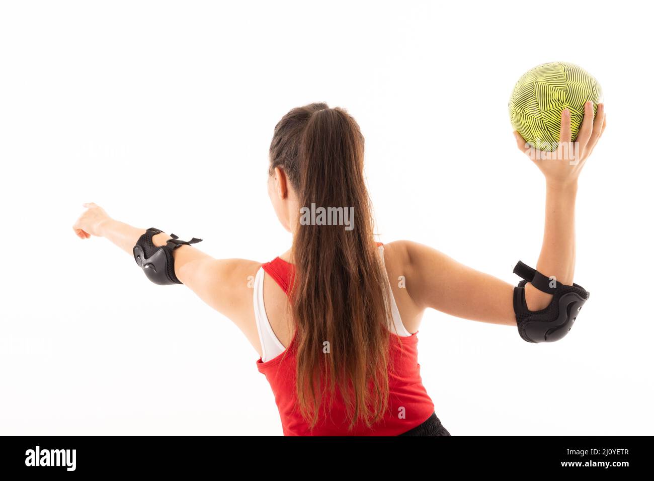 Rear view of caucasian young female player with arm outstretched and ...