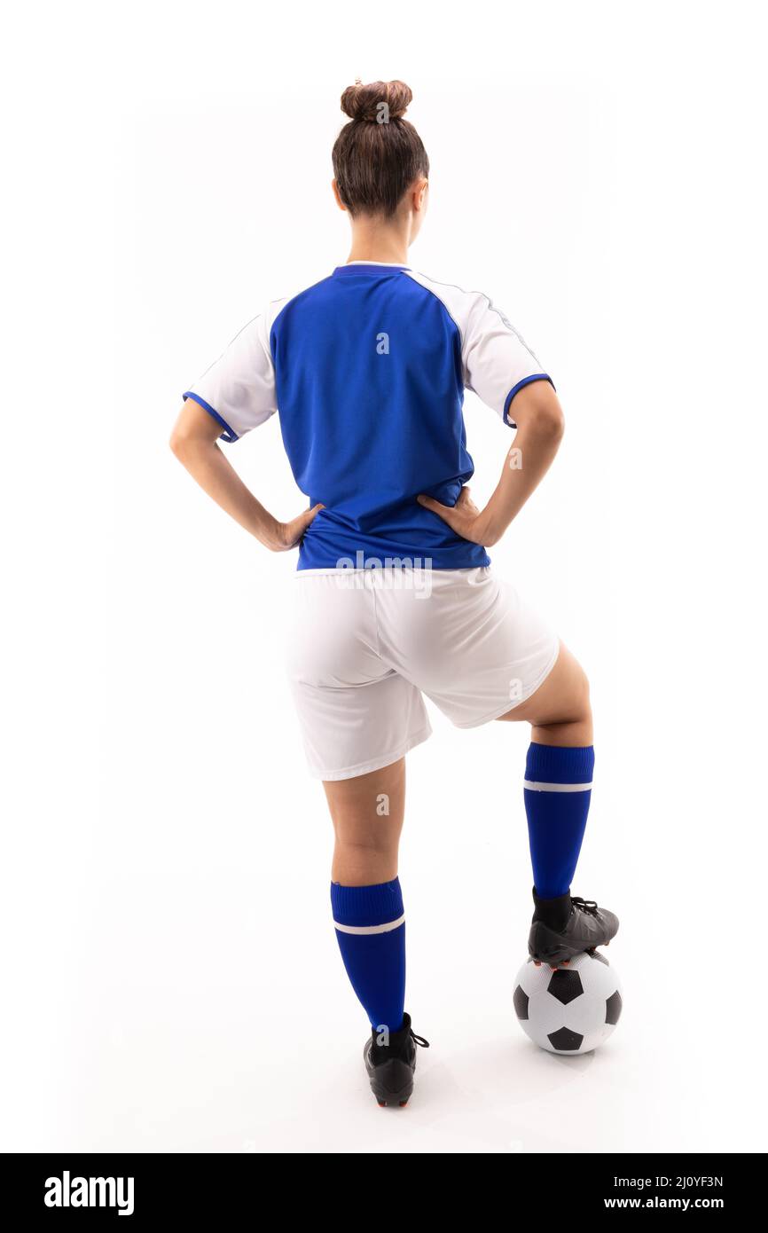 Rear view of biracial young female player with hand on hip standing on ...